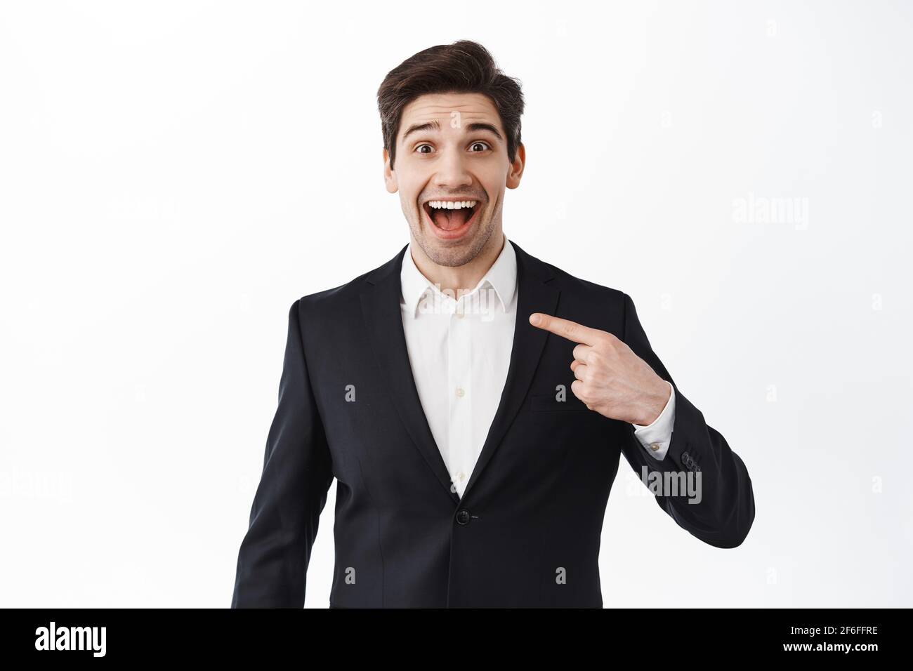 Excited and happy office worker, employee in formal black suit pointing ...
