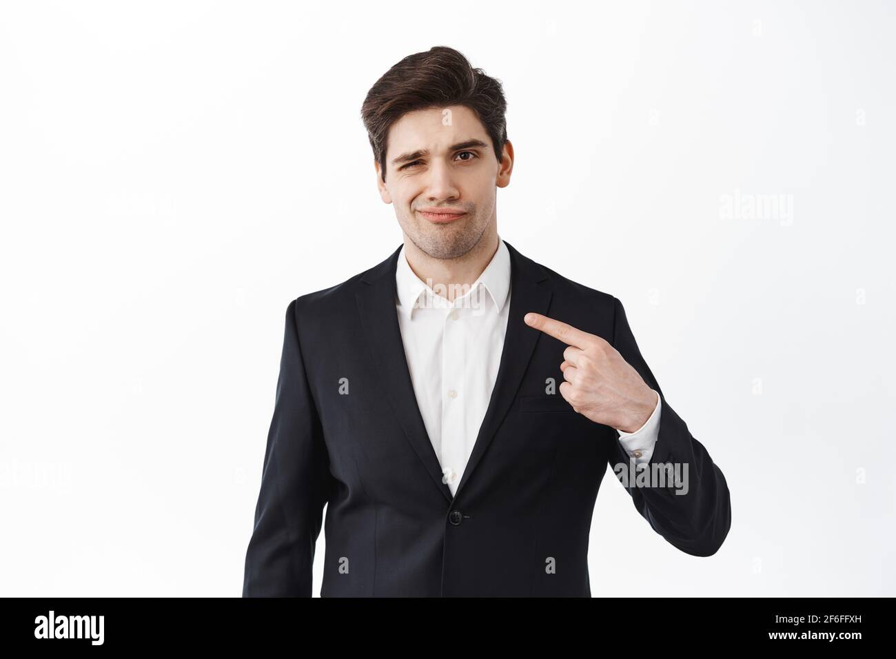 Doubtful and skeptical corporate man in black suit points at himself ...