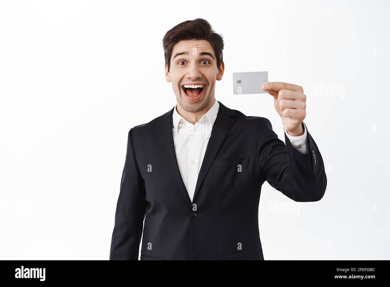 Bank advertisement. Excited businessman shows credit card and smiling ...