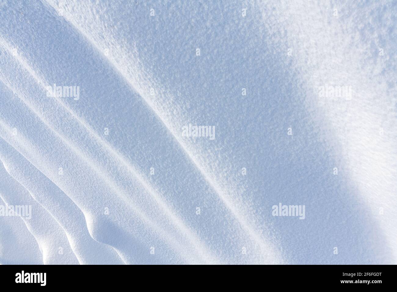 Winter season scene. Texture of snow waves in bright sunlight. With a ...