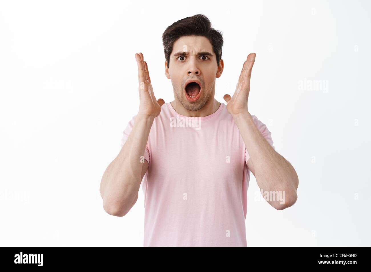 Frustrated and shocked man react to bad shocking news, stare startled ...