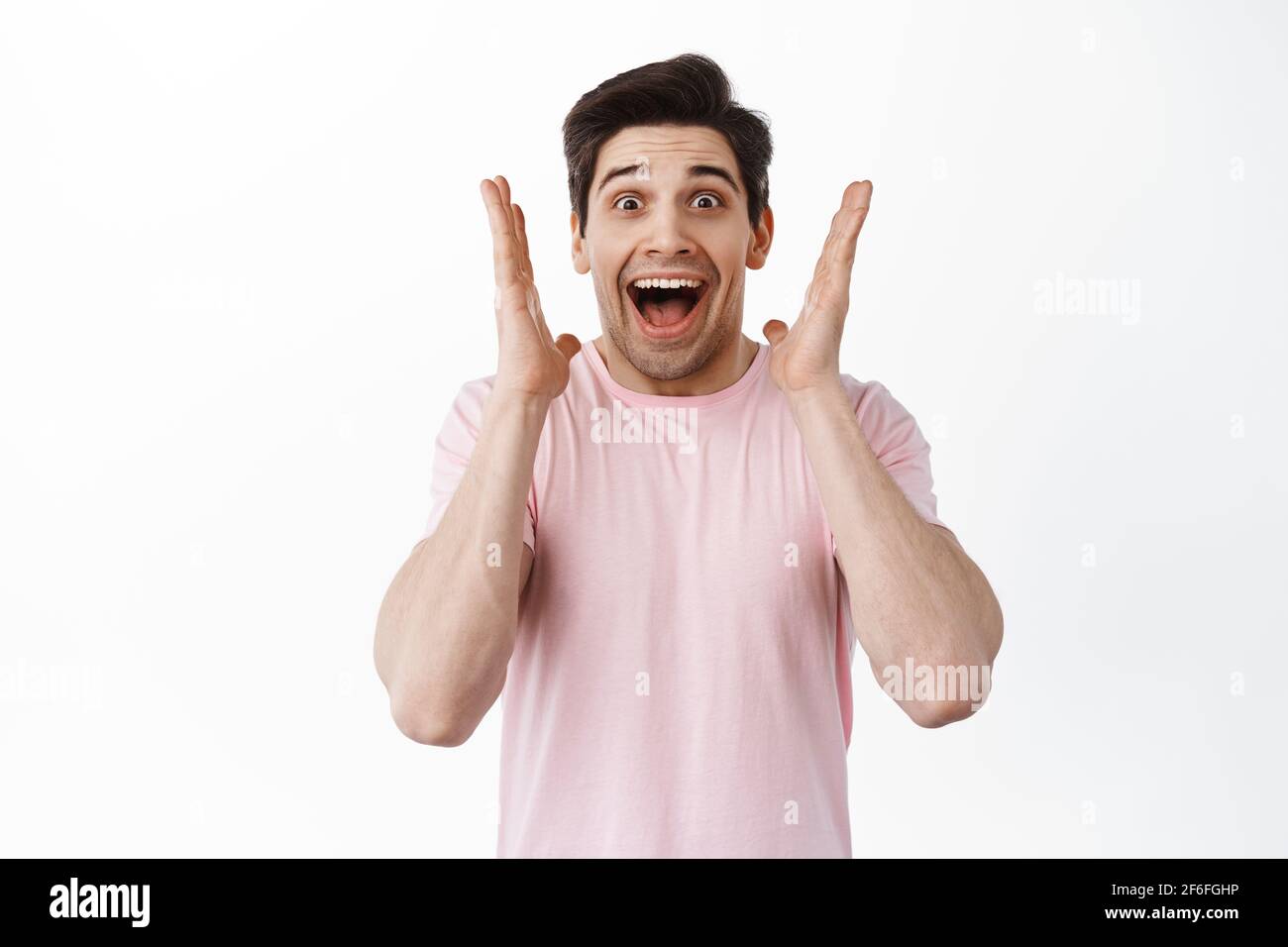 Surprised happy, relieved guy hear positive news, celebrating great ...