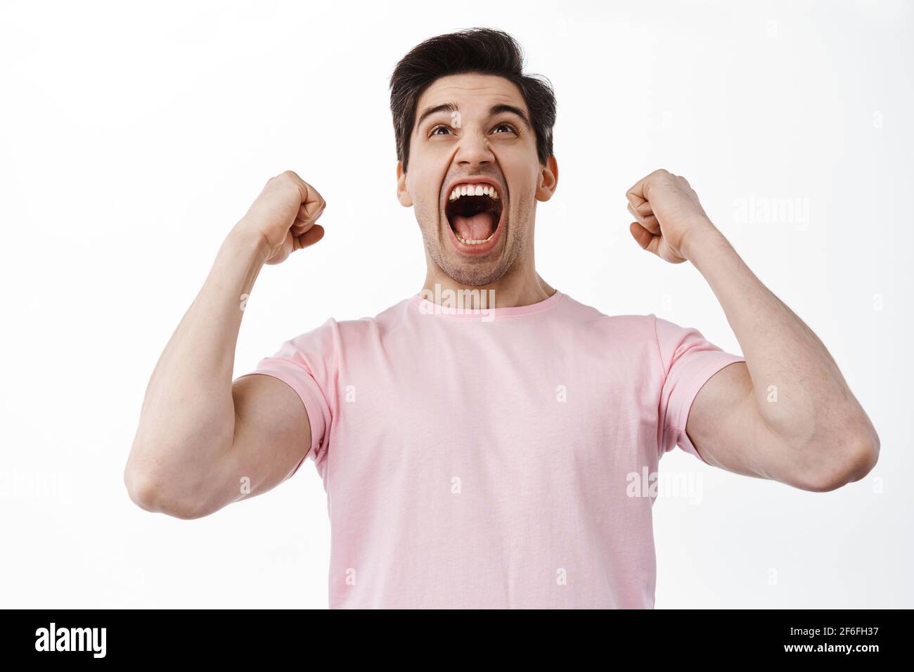 Success and celebration. Excited man looking up at screen, winning bet ...