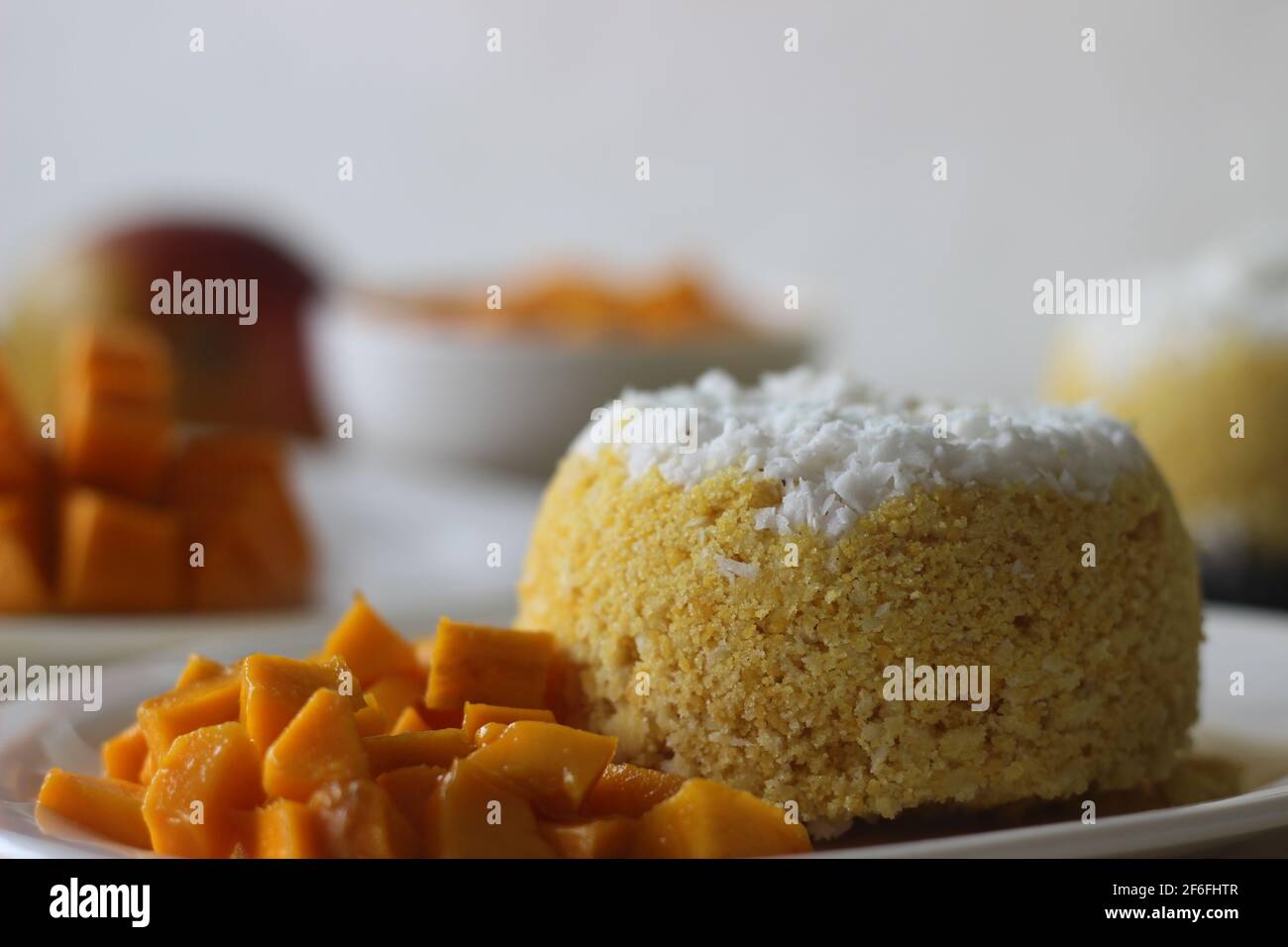 Steamed ground rice, layered with coconut shavings and mango. Locally ...