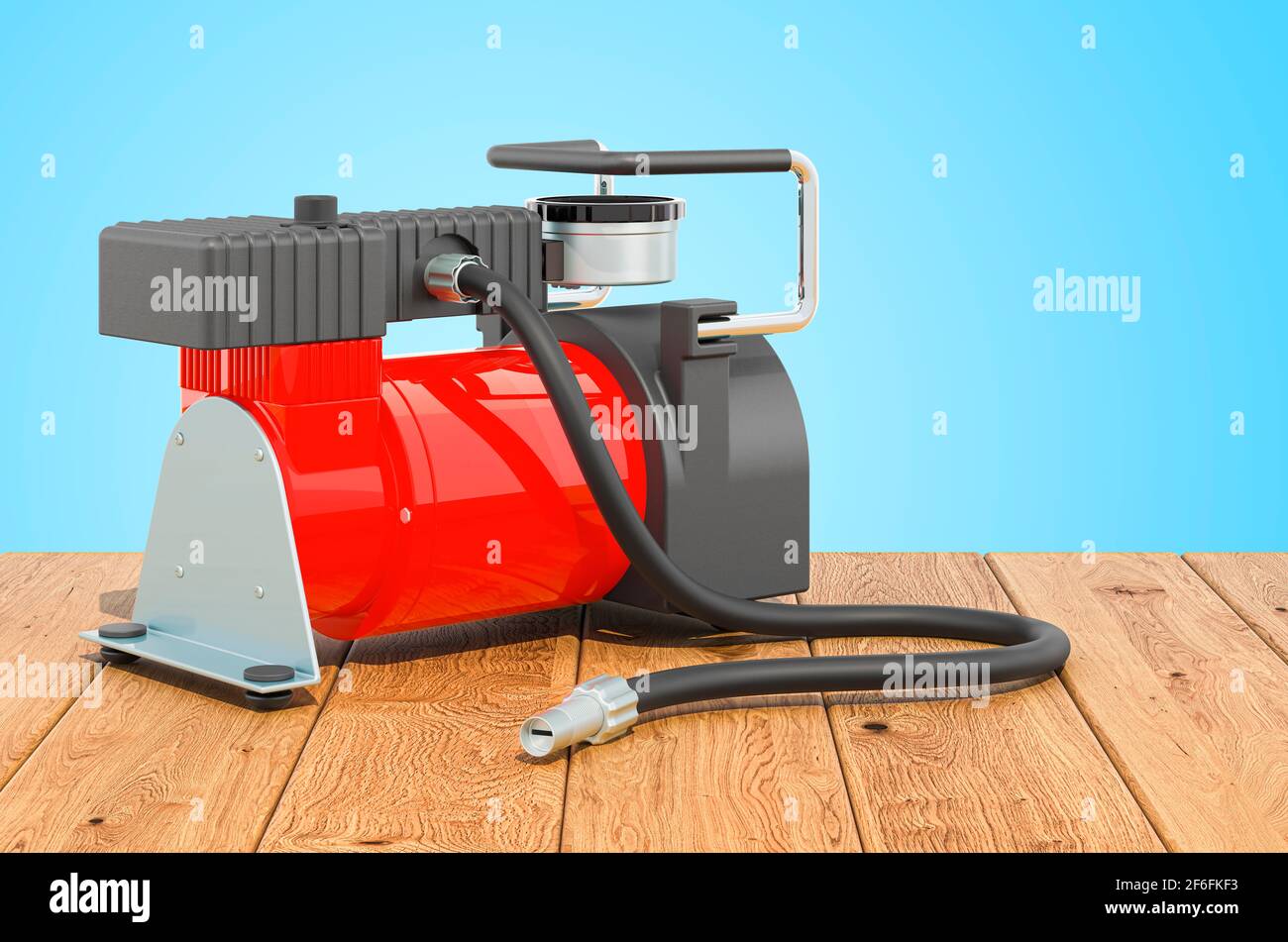 Car portable electric air compressor on the wooden table. 3D rendering ...