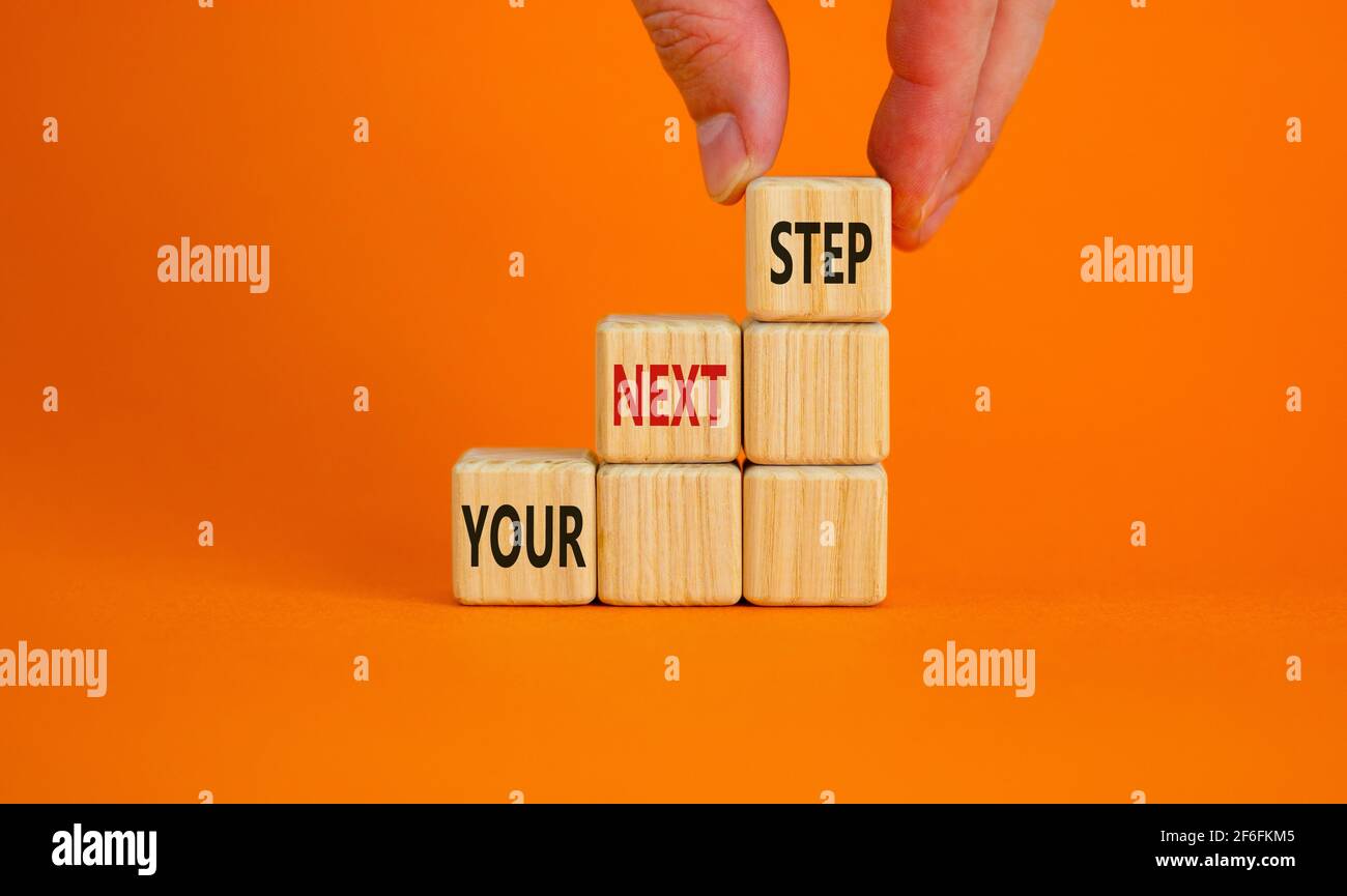 Your next step symbol. Hand arranging wood block stacking as step stair ...