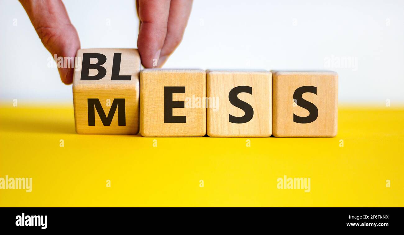 Bless mess symbol. Businessman turns the cube and changes the word ...