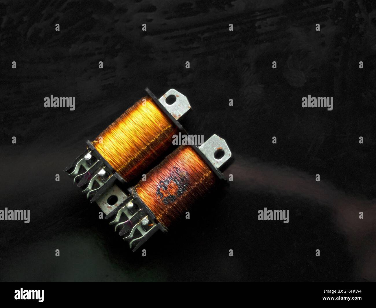 Burnt power transformer with copper winding Stock Photo - Alamy