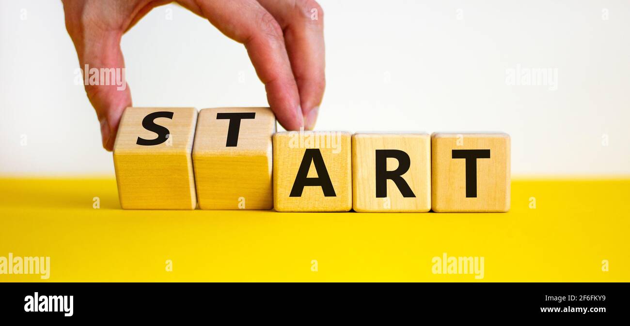 Start art symbol. Businessman turns cubes and changes the word 'start ...