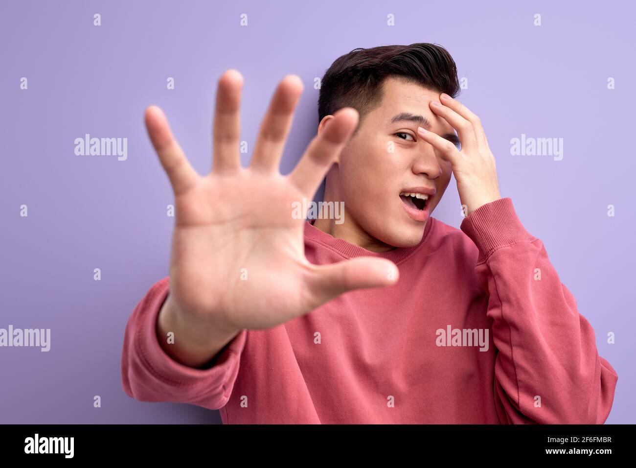 asian man over isolated background doing stop gesture with fear ...