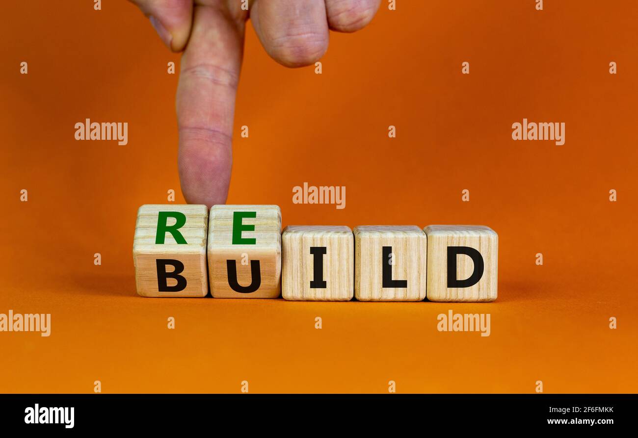 Rebuild symbol. Concept word 'rebuild' on wooden cubes on a beautiful ...