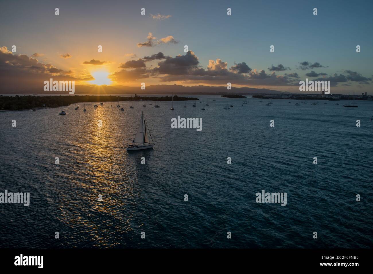 Sun setting over port in Caribbean island with yachts Stock Photo - Alamy