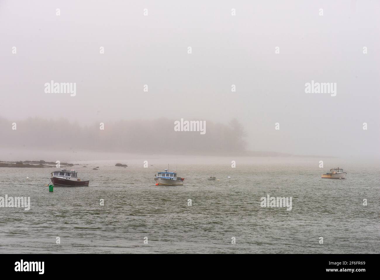 Boats in a misty harbor, Harrington, Maine Stock Photo - Alamy