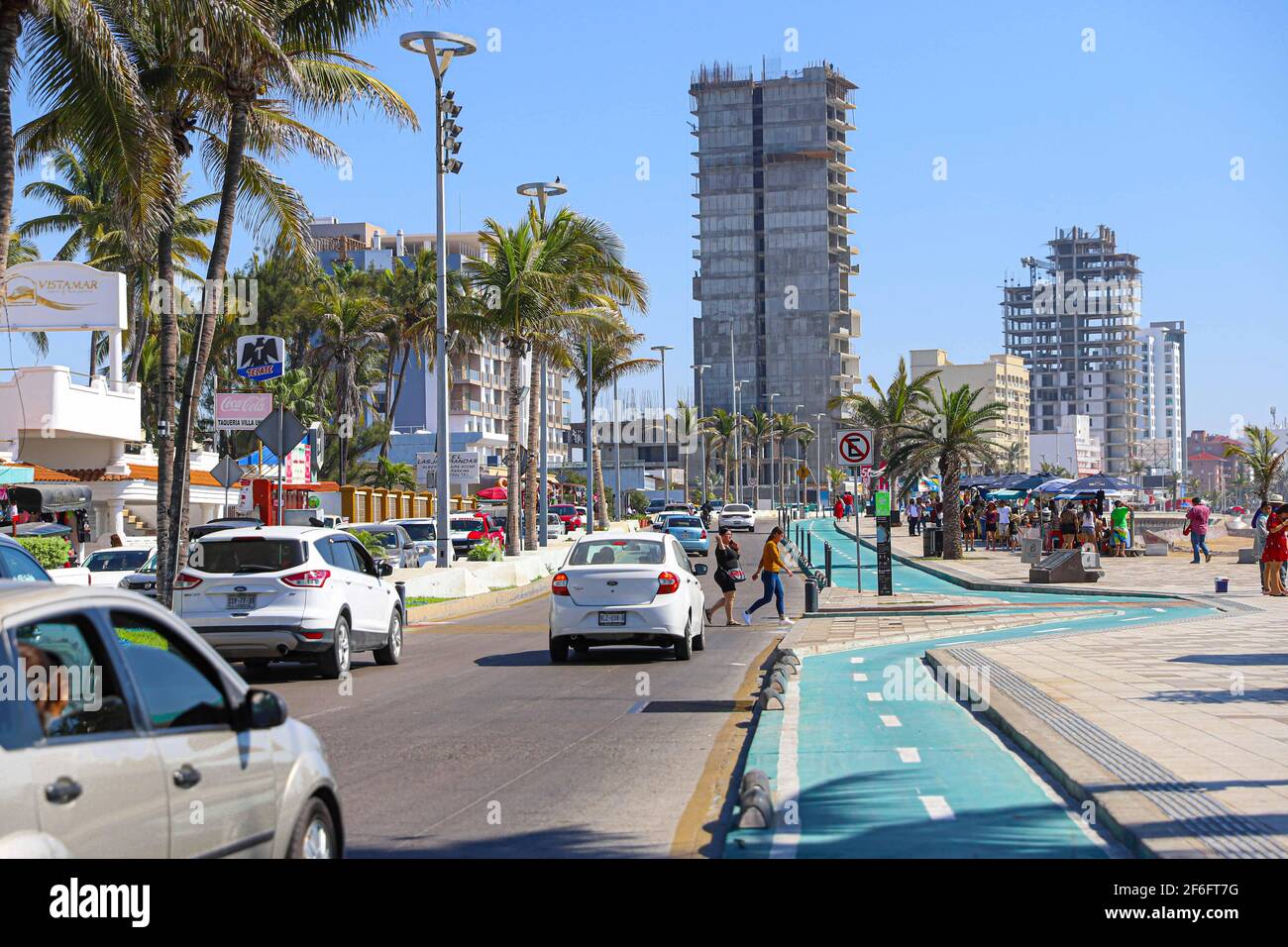 Cycle road and cyclist on the tourist boardwalk in the bay or beach in ...