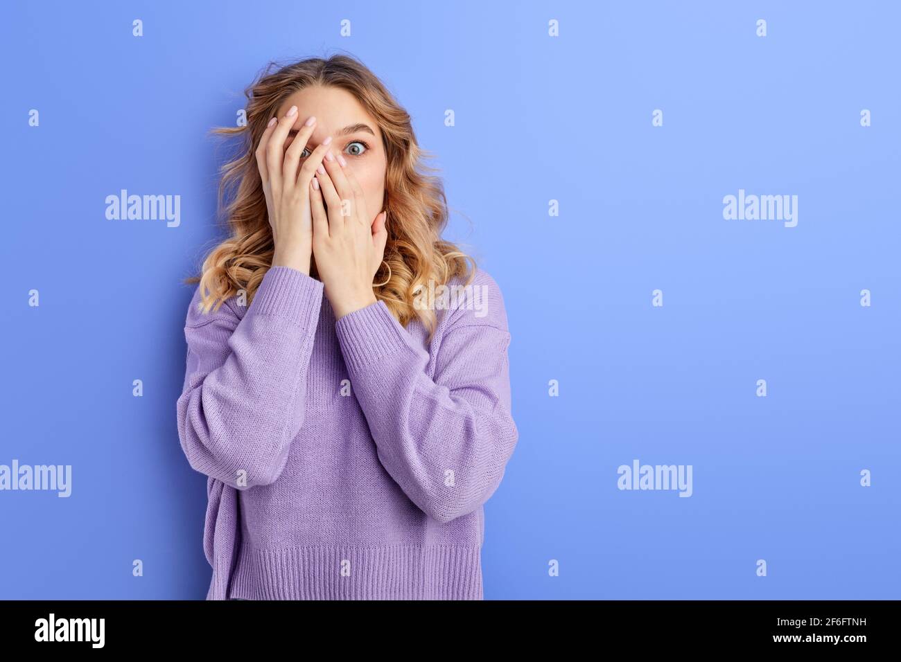 Frightened female closing face in shock, stand in fear, wearing casual ...
