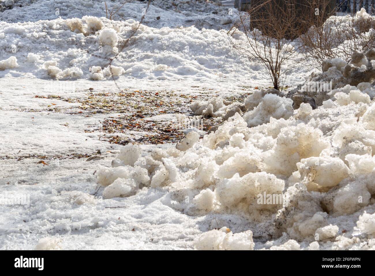 Early spring time dirty gray melted snow with sand pattern texture ...