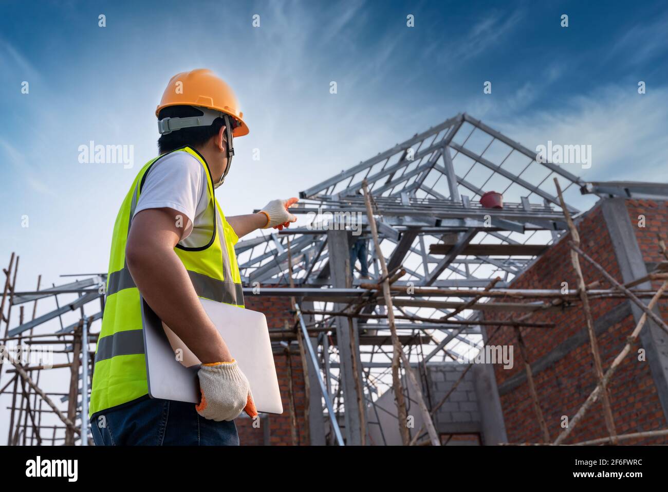 Engineer technician Looking Up roof structure and Analyzing an ...