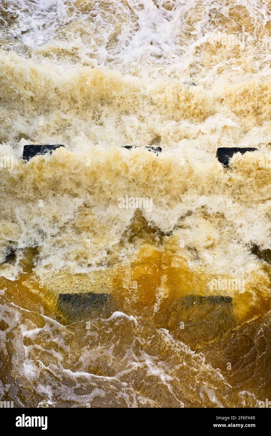 Water turbulent flowing out of the weir Stock Photo - Alamy