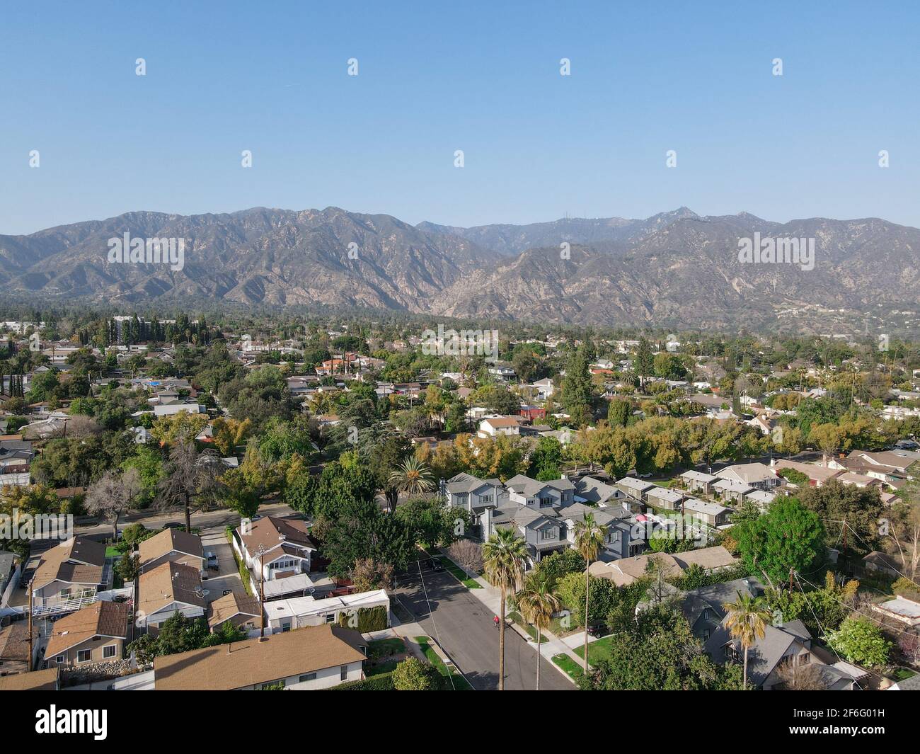 Aerial view above Pasadena neighborhood with mountain in the background ...