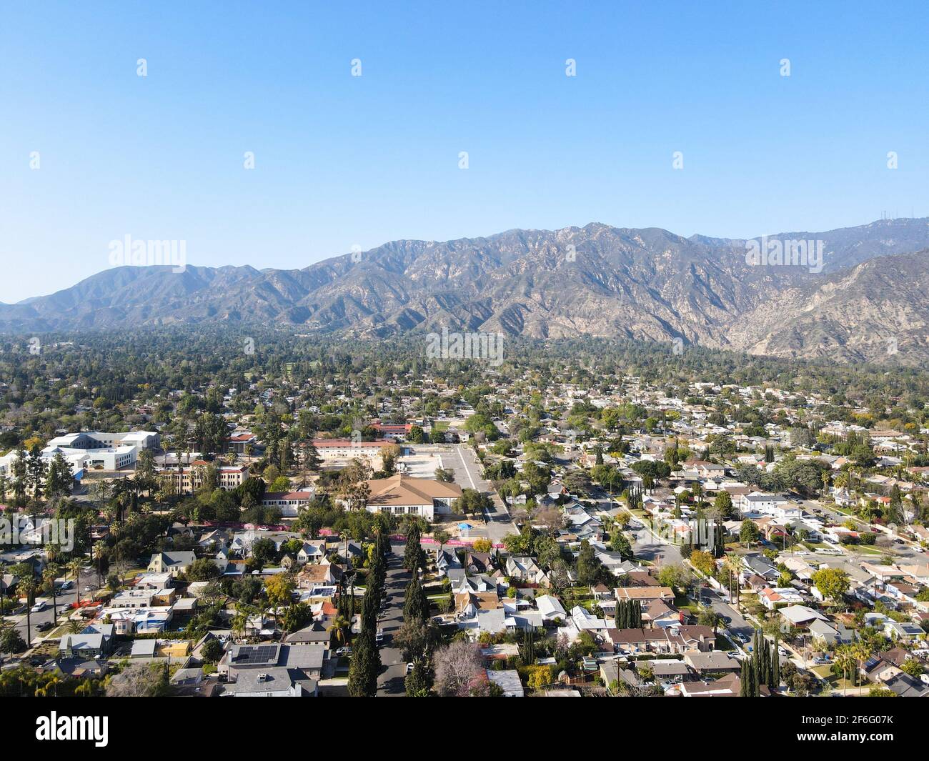 Aerial view above Pasadena neighborhood with mountain in the background ...