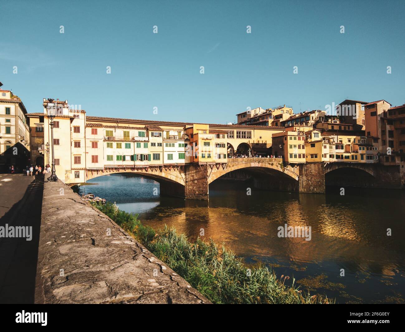 Famous Ponte Vecchio closed-spandrel segmental arch bridge across river ...