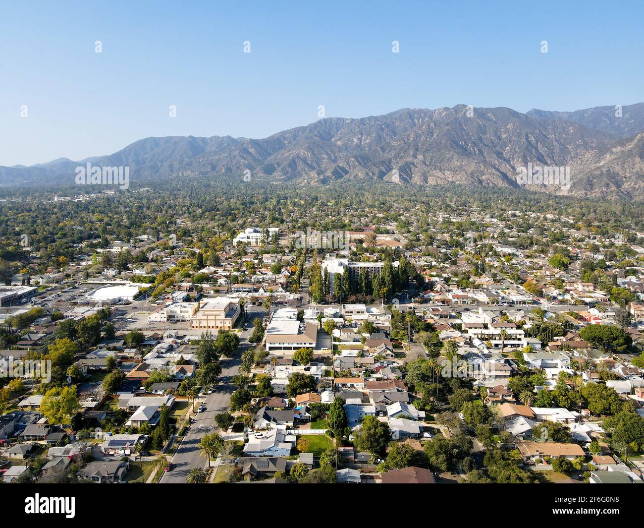 Aerial view above Pasadena neighborhood with mountain in the background ...