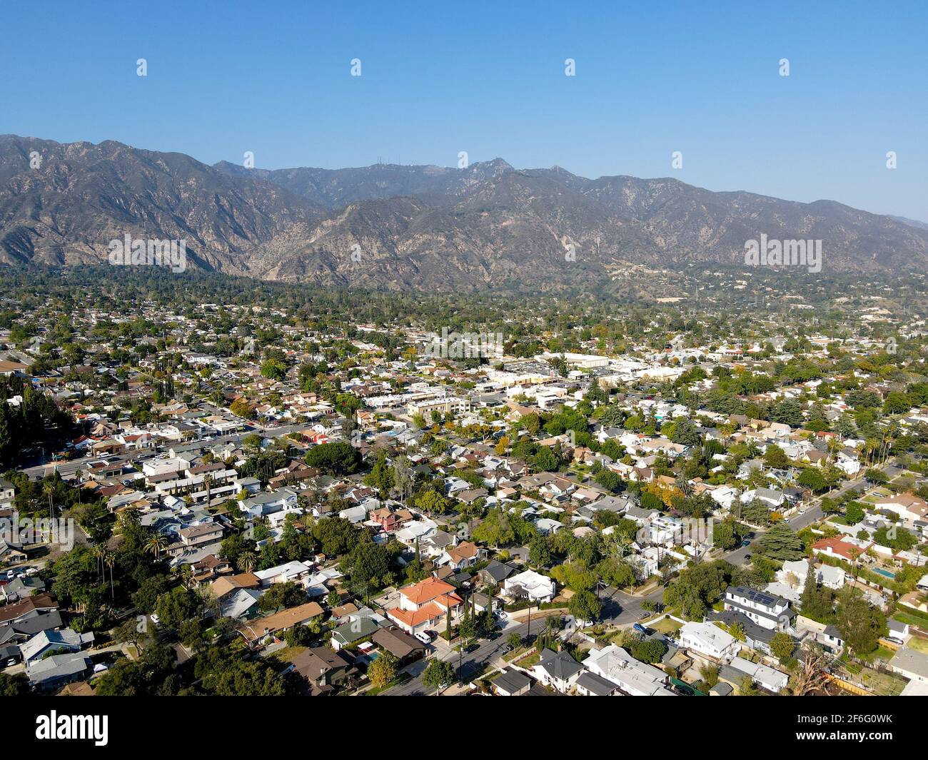 Aerial view above Pasadena neighborhood with mountain in the background ...