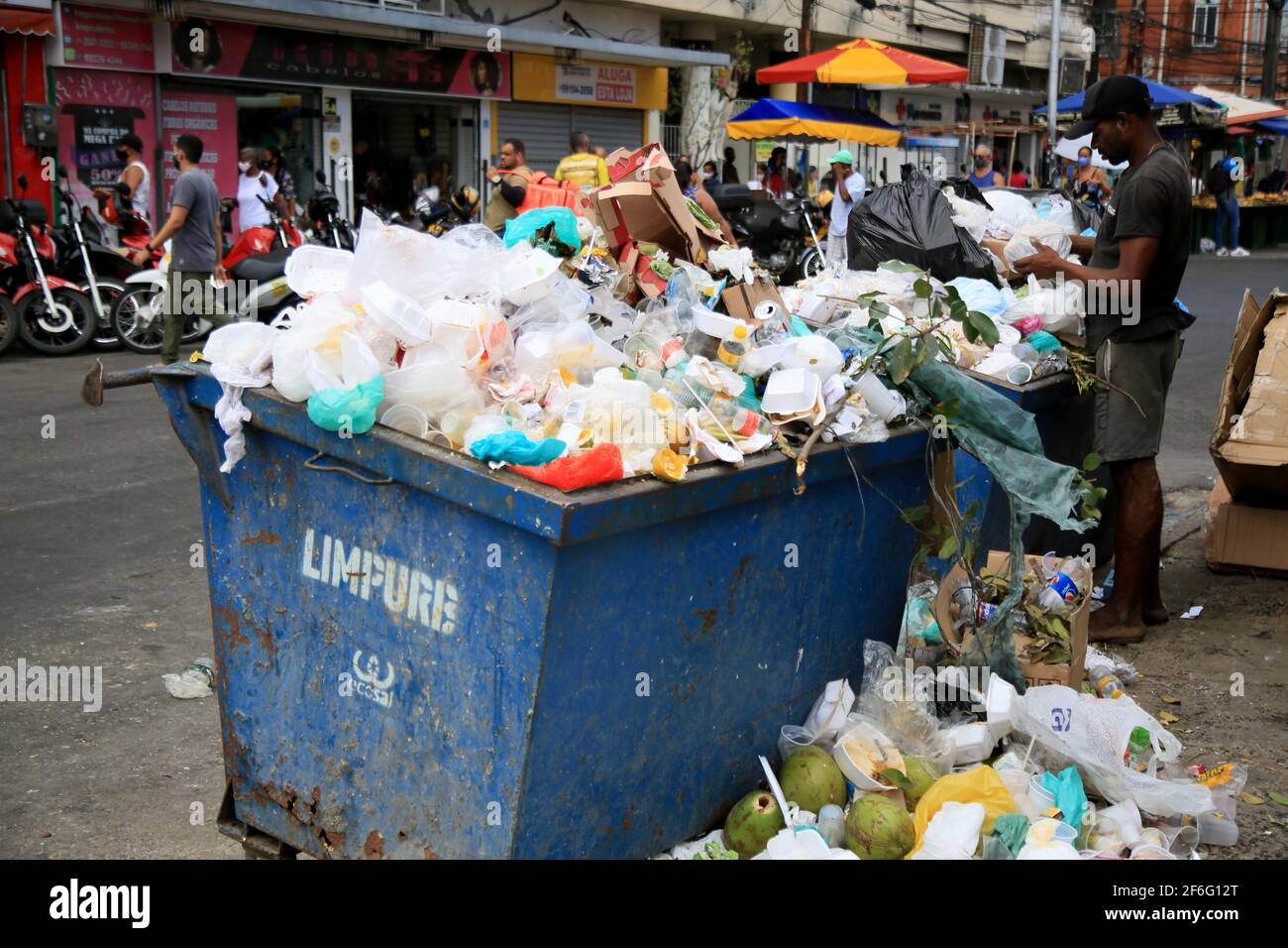 salvador, bahia, brazil - december 16, 2020: man turns over garbage ...