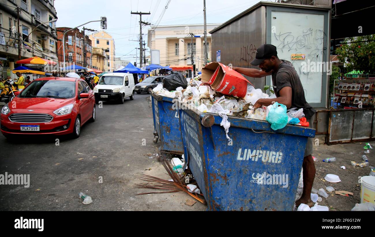 salvador, bahia, brazil - december 16, 2020: man turns over garbage ...