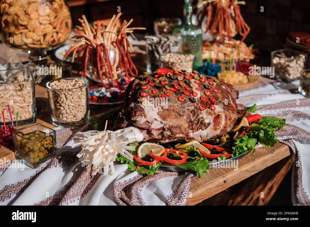 Baked pork leg with vegetables at a buffet table. Catering Stock Photo ...