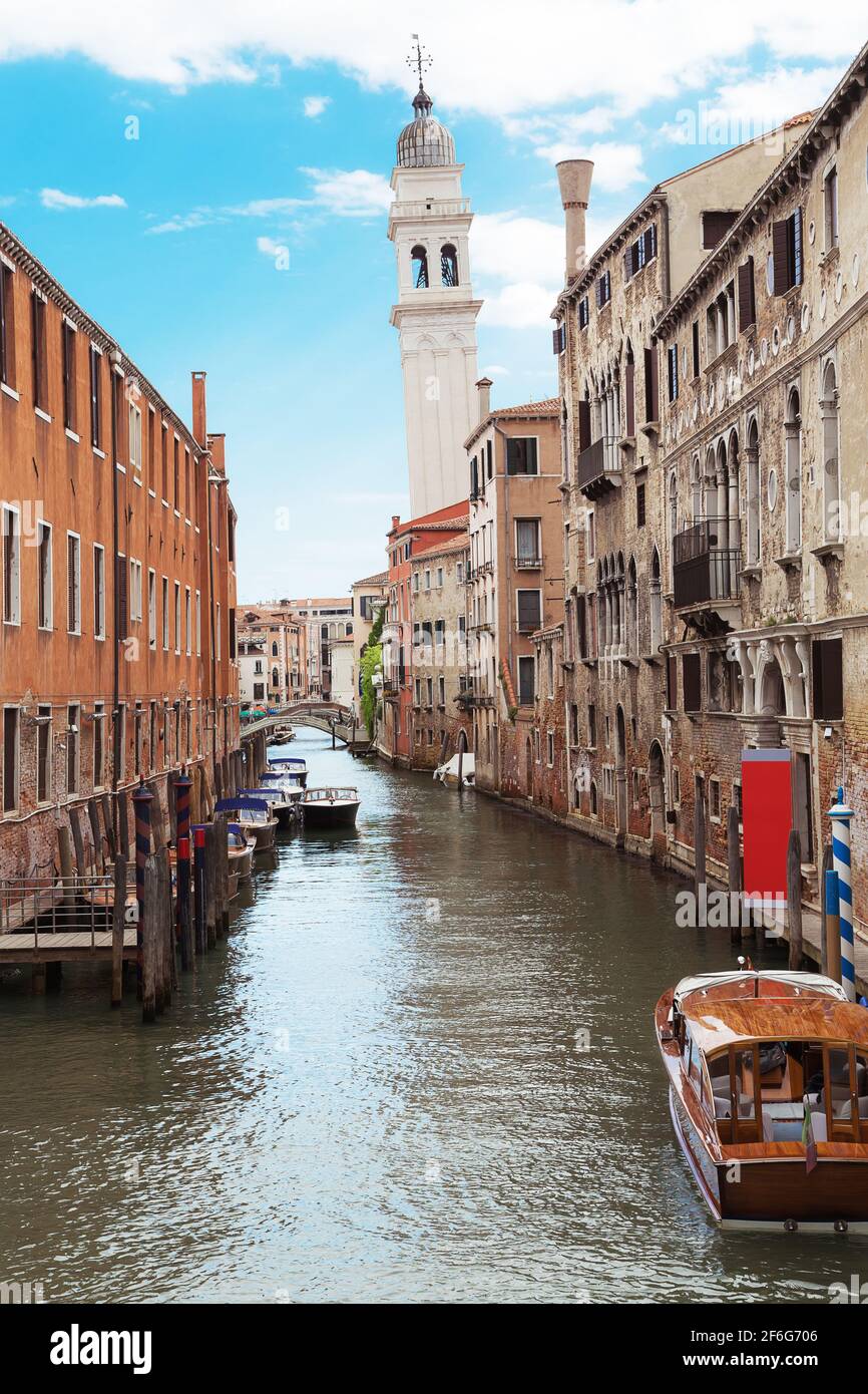 Italy. Venice. Water channel and a view of the leaning bell tower of ...