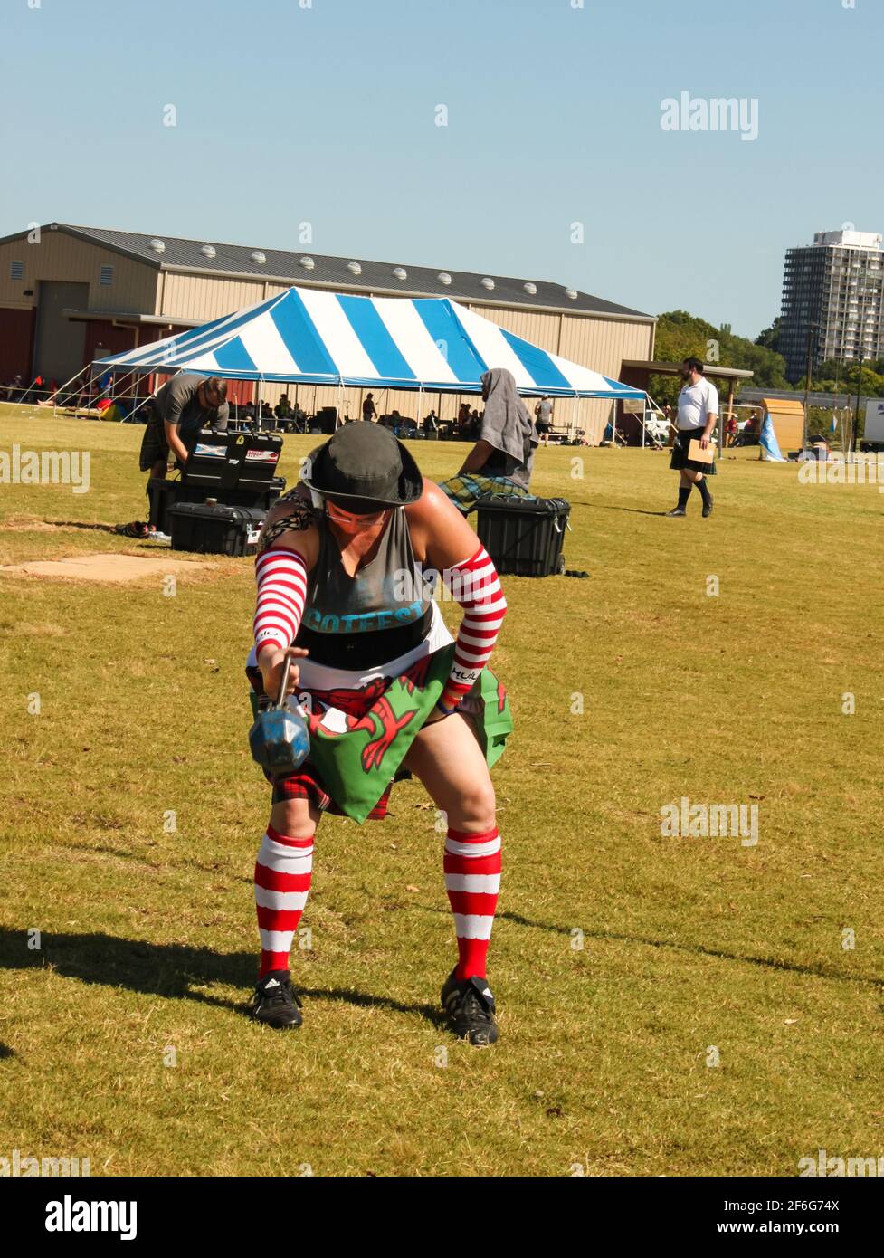 Woman competing in Weight of height strength test at Scottish Highland ...