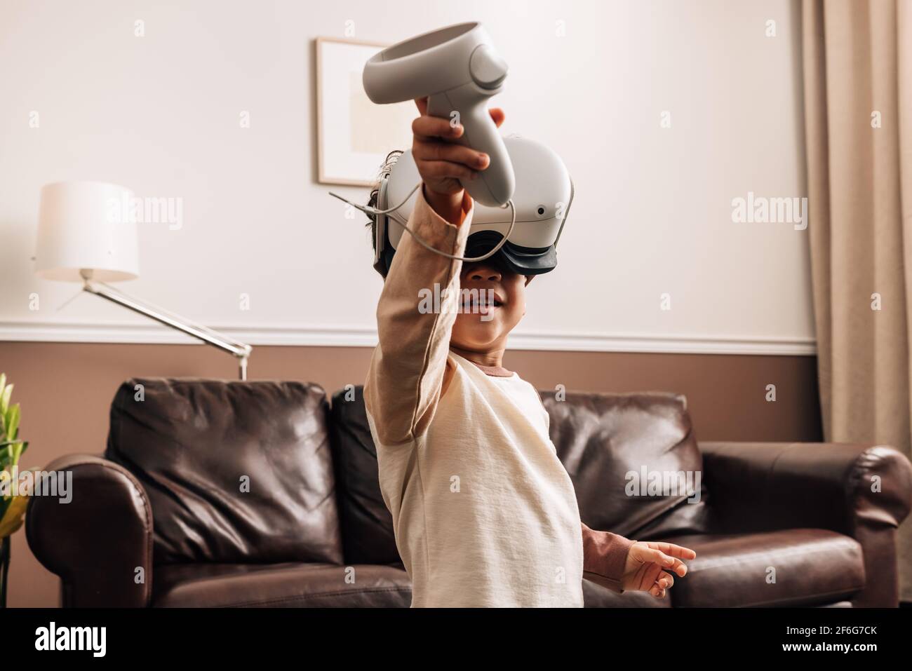 Kid playing virtual reality games at home. Little boy having fun Stock ...