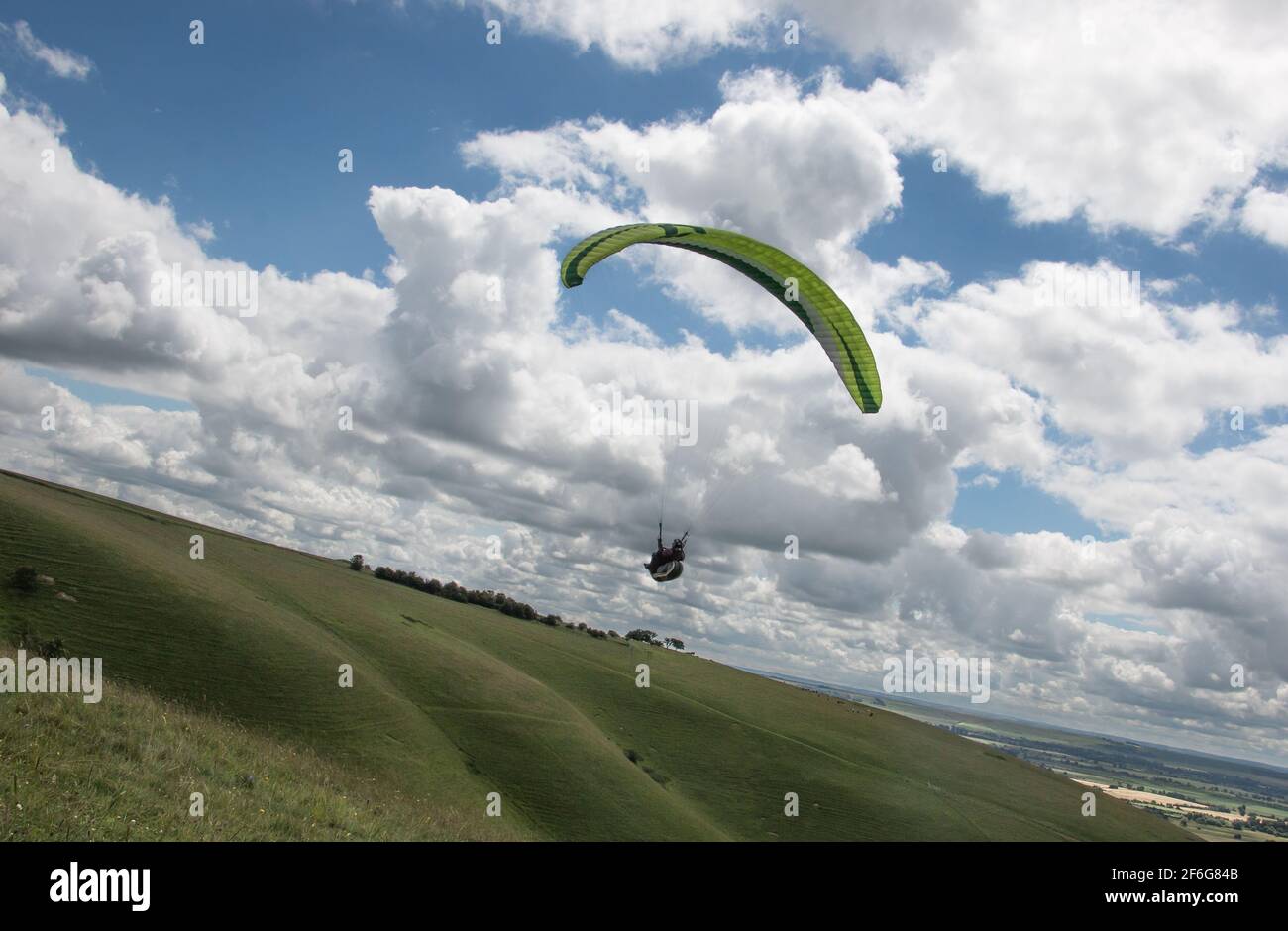 Lonely paraglider flying above English rural area Stock Photo - Alamy