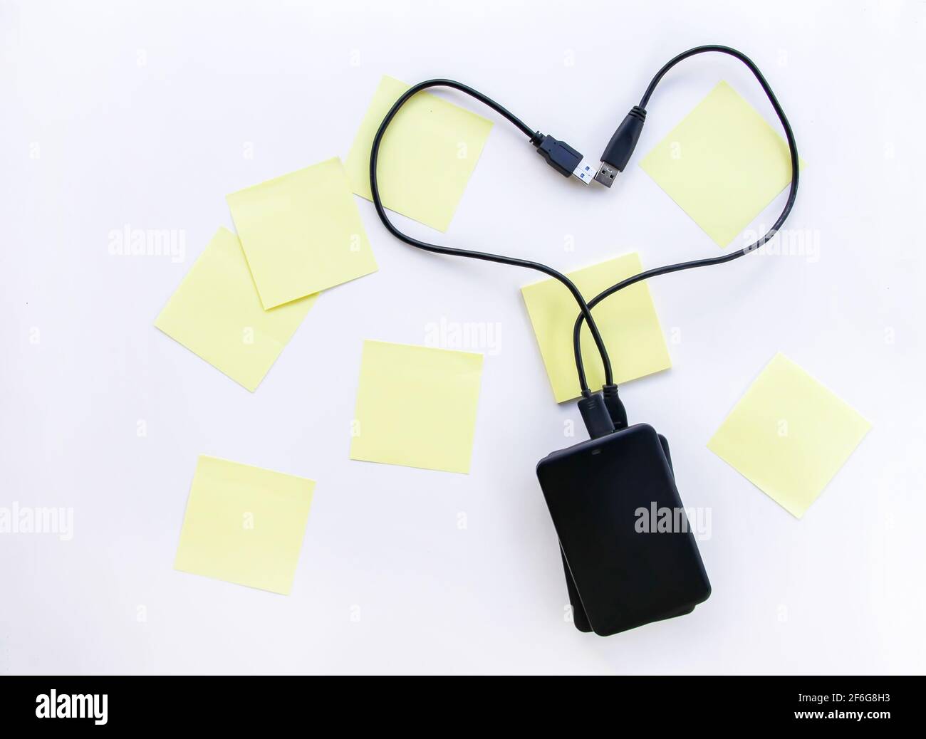 Composition with two external black hard drives and colorful paper ...