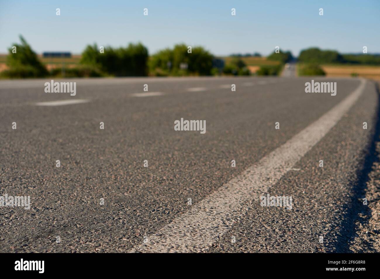 soft focus asphalt road surface with white markings close-up from the ...
