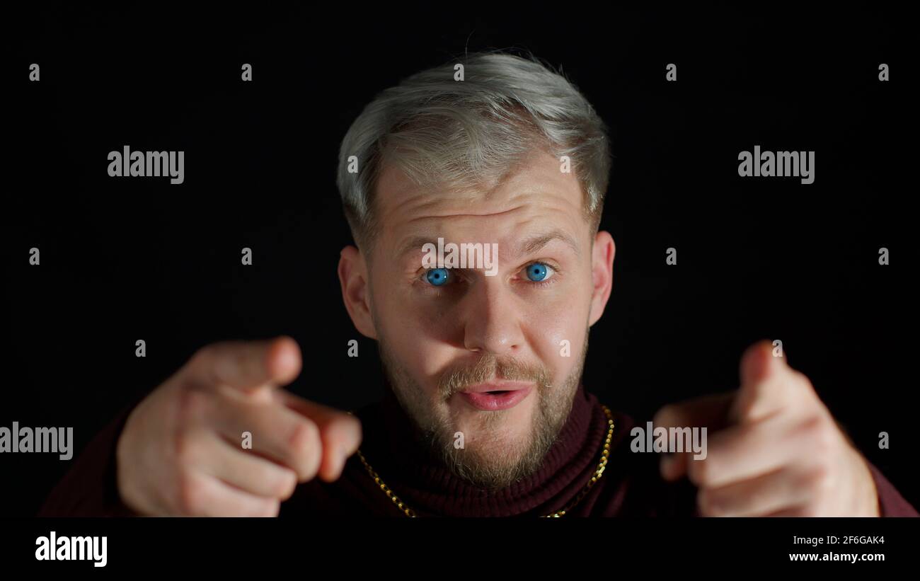 Glad happy stylish young man smiling excitedly and pointing to camera ...
