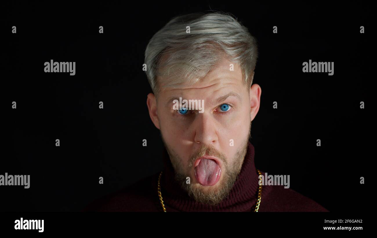 Comical stupid stylish man making funny silly face grimace, playing ...