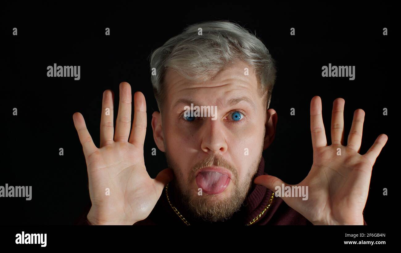 Comical stupid stylish man making funny silly face grimace, fooling ...