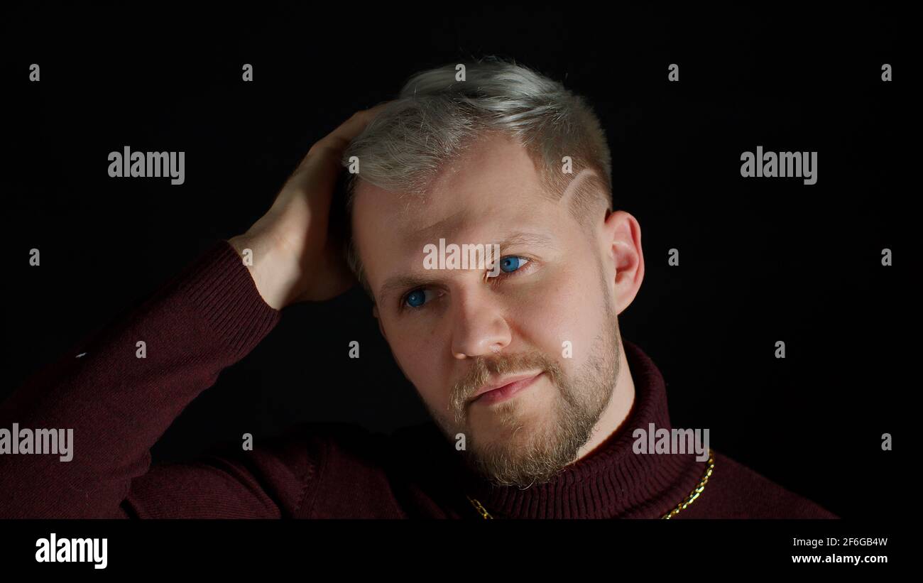 Smiling cheerful young man in trendy stylish clothes holding hand over ...