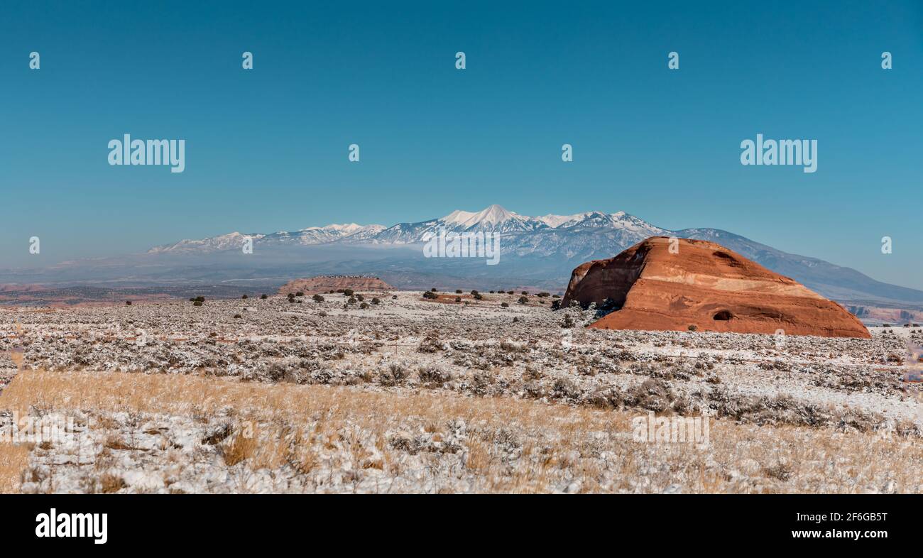 Winter landscape in Utah with snow covered meadows and the Rockies in ...