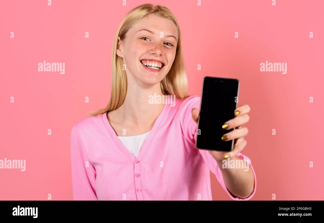 Happy girl with smartphone with empty screen. Advertising new model ...