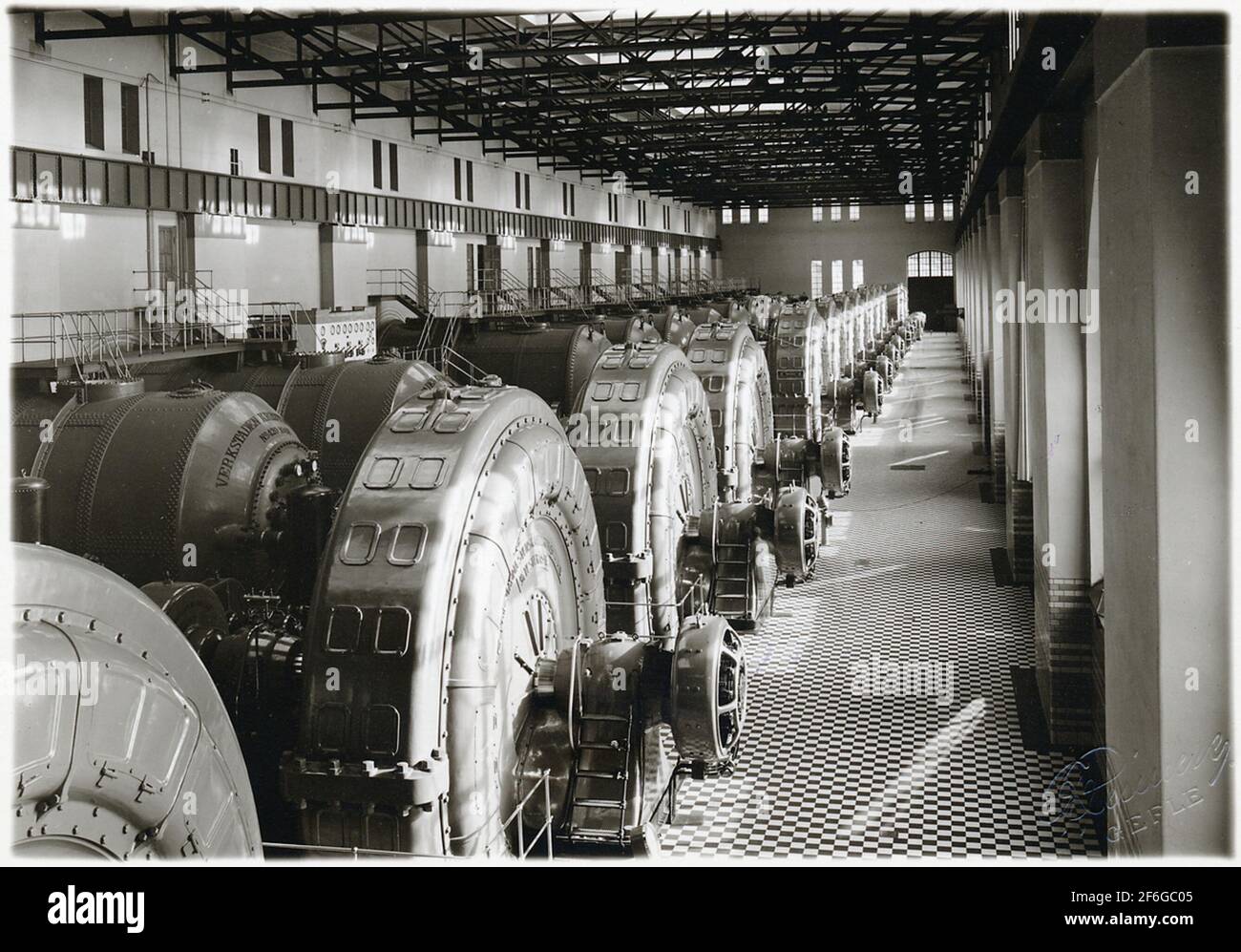 Interior image of turbines in the machine room. The power station is ...