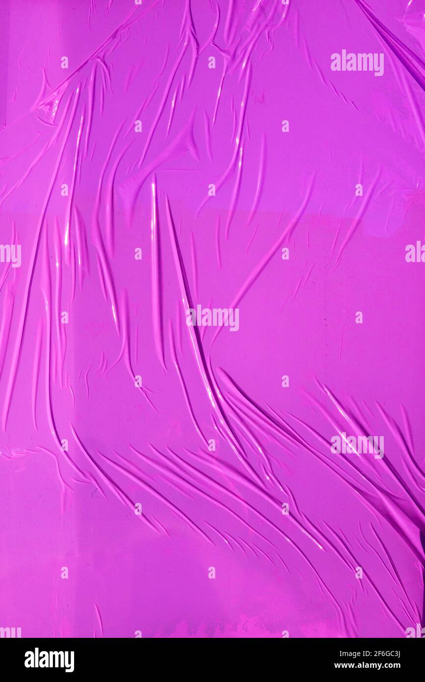 Uneven hot pink platic on flat surface with lines of air pockets and ...