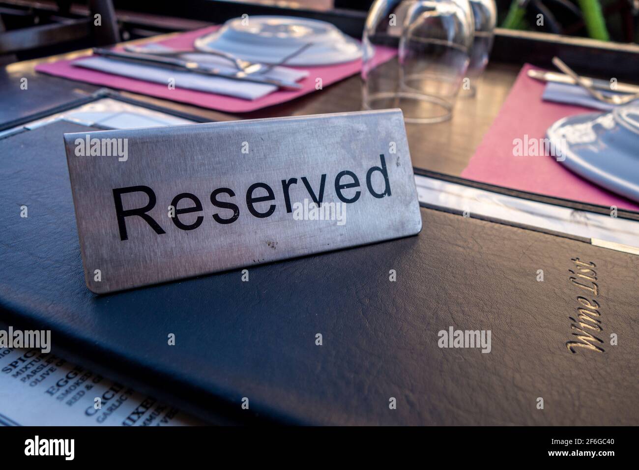 Reserved sign on VIP list, prepare table with menu and wine list menu ...