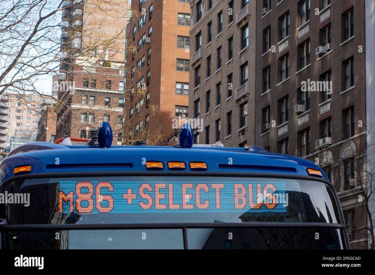Blue commuter urban city bus m86 + select bus Stock Photo - Alamy
