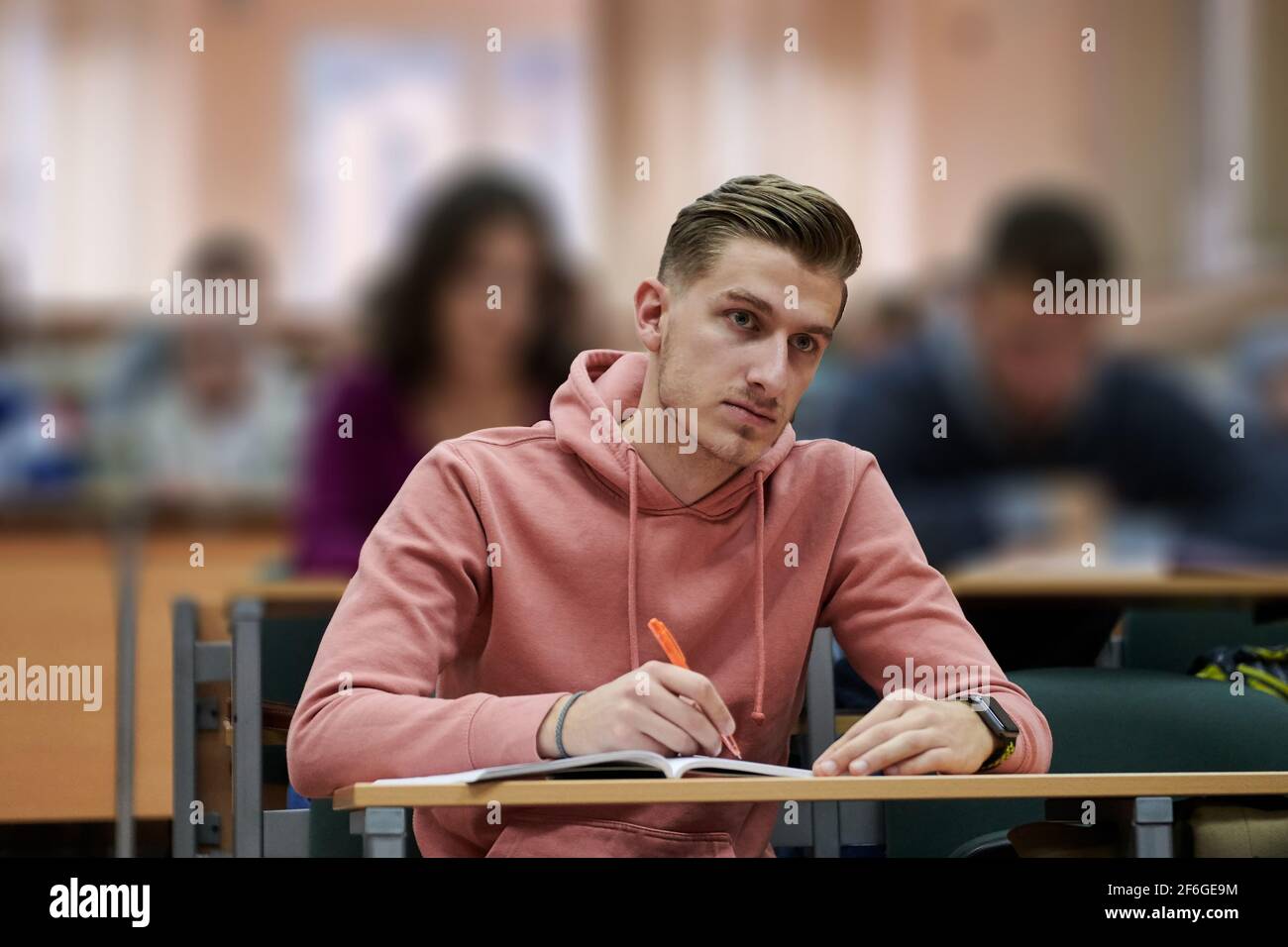 student taking notes while studying in high school. Portrait of college ...