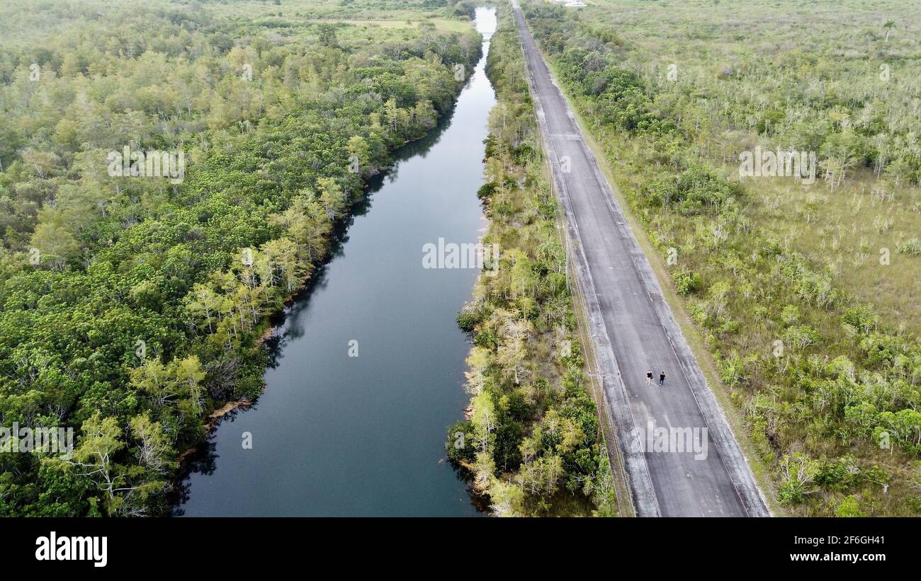 Aerial View of Two People Walking on Abandoned Road Stock Photo - Alamy