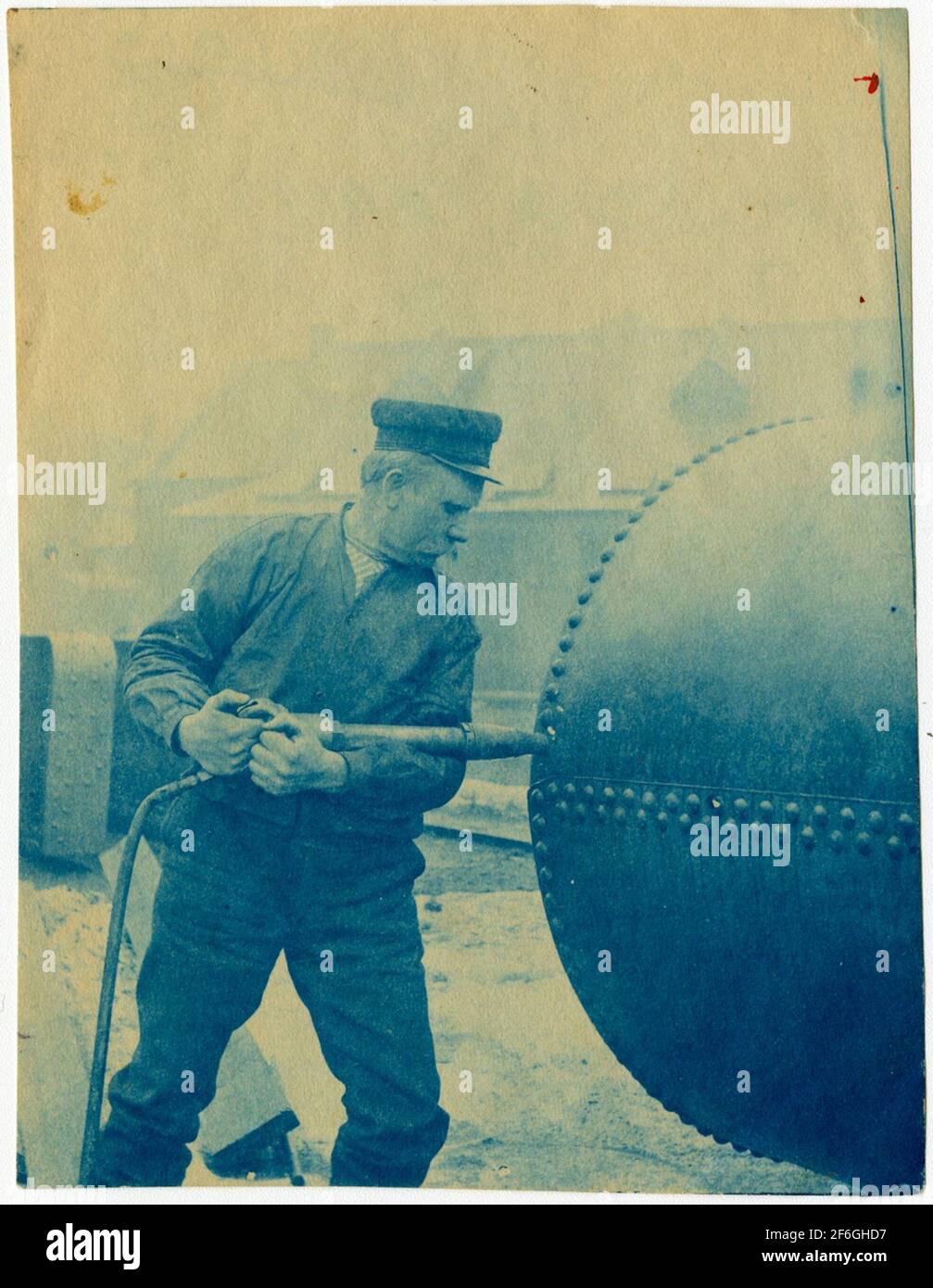 Man who rivets a boiler Stock Photo - Alamy