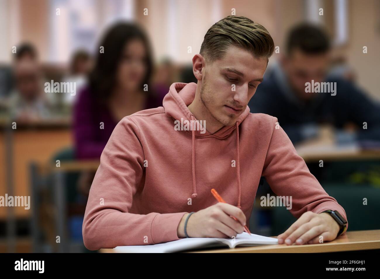 student taking notes while studying in high school. Portrait of college ...